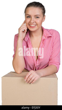 Woman leaning on cardboard box Stock Photo - Alamy