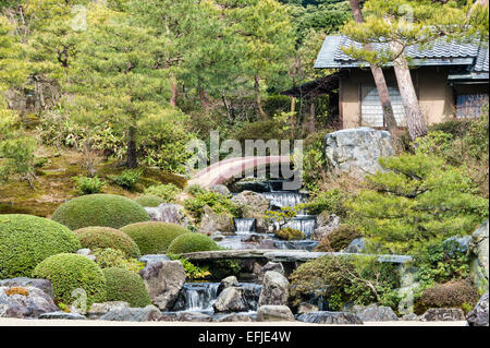 Matsue, Japan. Bridges across a stream lead to a tea house in the 20c ...