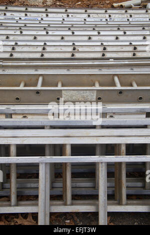 Stack of ladders on ground at a construction site Stock Photo - Alamy