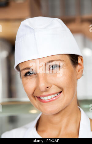 Portrait of pretty female butcher smiling at butchery Stock Photo - Alamy