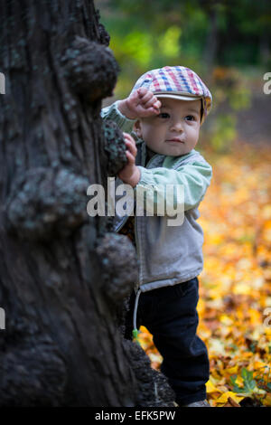 Cute little boy near light wall Stock Photo - Alamy