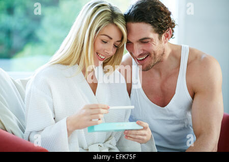 Woman happy with results of pregnancy test Stock Photo - Alamy