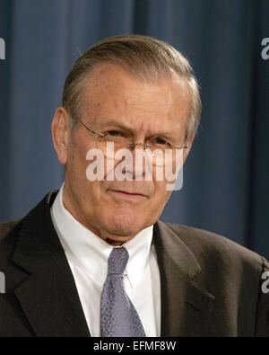 US Defence Secretary Donald Rumsfeld looks at a chart showing ...