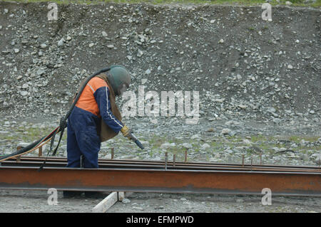 tradesman sandblasting I beams for building project Stock Photo - Alamy