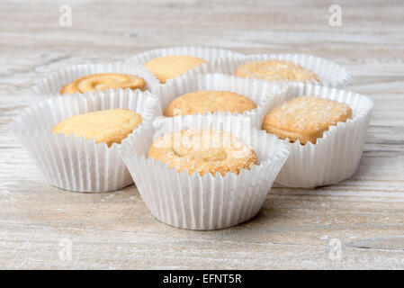 Butter cookies in a paper packing on a wooden table Stock Photo - Alamy