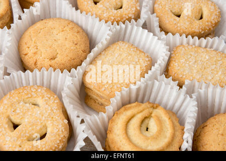 Butter cookies in a paper packing on a wooden table Stock Photo - Alamy