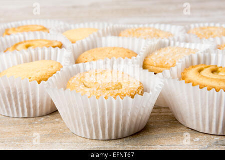Butter cookies in a paper packing on a wooden table Stock Photo - Alamy