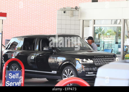 David Beckham drives his black Range Rover Autobiography to a petrol ...
