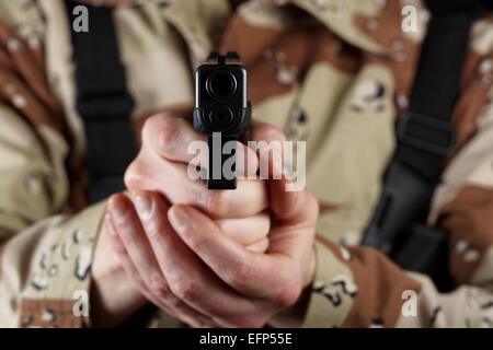 Soldier pointing a pistol Stock Photo - Alamy