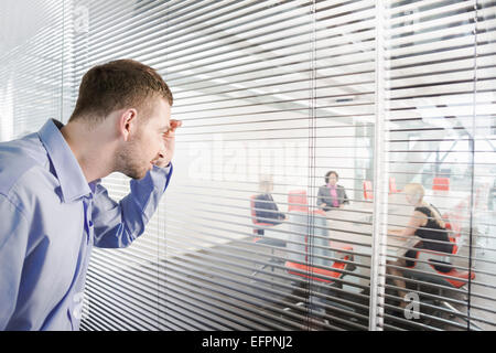 Man looking through window Stock Photo - Alamy
