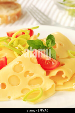 Slices of Swiss cheese sprinkled with chopped leek Stock Photo - Alamy