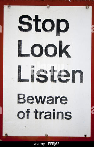 Signs 'Stop Look Listen', 'Beware of trains' and 'Warning do not Stock ...