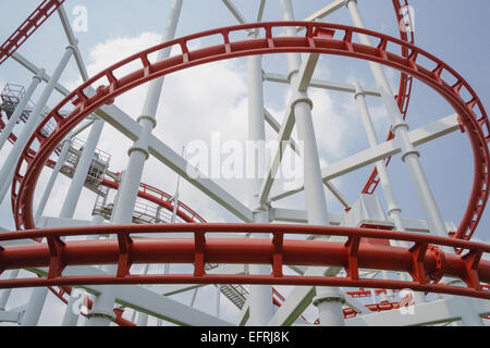 round turn of red roller coaster rail in amusement park look exiting ...