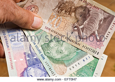 Hand and banknotes, Rand or ZAR, the currency of South Africa Stock ...