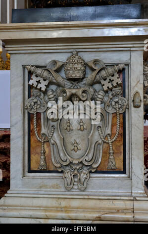 Stone carvings of the papal emblem on a white monument in the square in ...