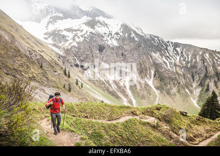 Germany, Bavaria, Oberstdorf, man on a hike in the mountains at sunset ...