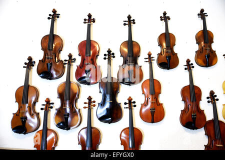 Violins hanging on a wall Stock Photo - Alamy