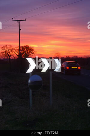 warning sign of sharp bend and circular safety mirror to give drivers ...