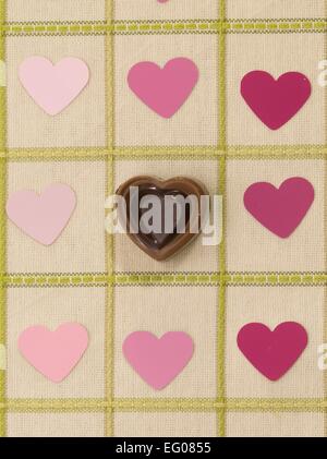 chocolate heart surrounded by paper hearts Stock Photo - Alamy
