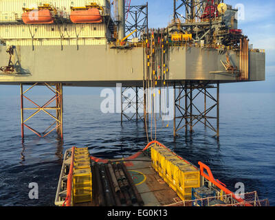 Oil rig support vessel approaching oil rig Stock Photo - Alamy