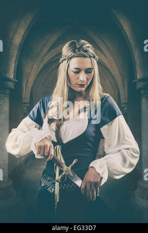 Young woman holding a dagger Stock Photo - Alamy