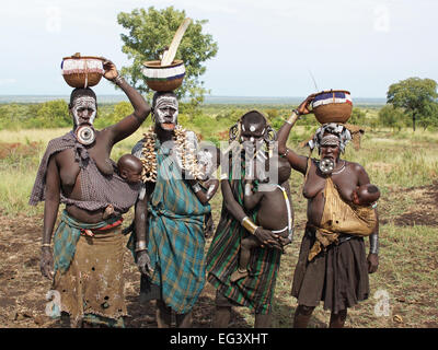 Mursi People Children in National Costumes in the Tribe Village Stock ...