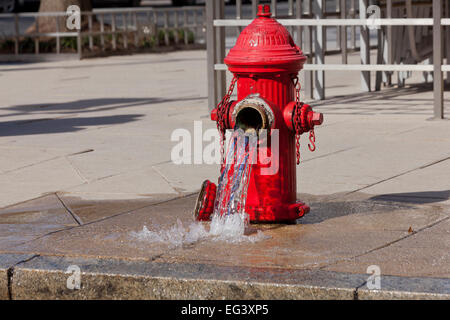 Red Fire Hydrant with Running Water pouring out Stock Photo - Alamy