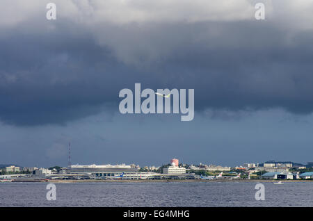 Naha Airport as seen from sea with a departing ANA plane during ...