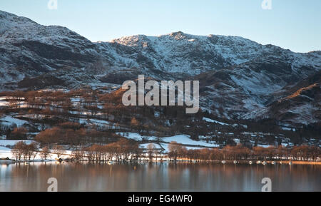 Coniston village sits at the bottom of the mountains in the snow at the ...