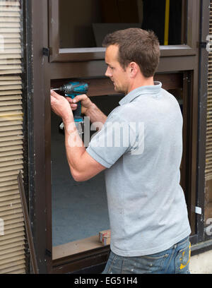 Construction worker installing window in house Stock Photo - Alamy