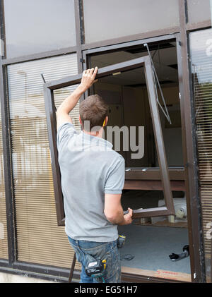 Workers are installing a window Stock Photo - Alamy