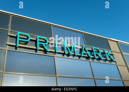 Close up of blue Primark shop front store sign & shopper people walking ...