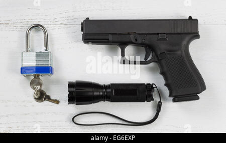 Overhead angled view of security items consisting of pistol, flashlight ...