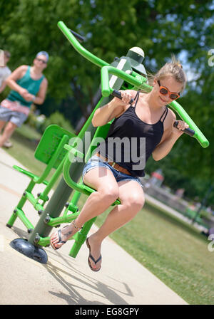 sporty young woman makes stretching exercises on grass Stock Photo - Alamy