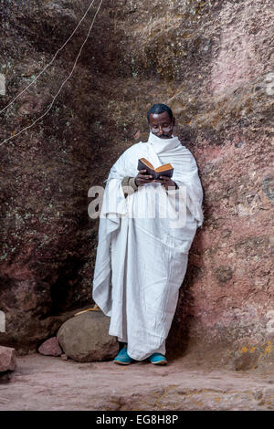 An Ethiopian Orthodox Christian pilgrim reading the bible in Amharic ...