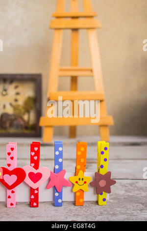 Colorful peg in a row on the wooden floor Stock Photo - Alamy