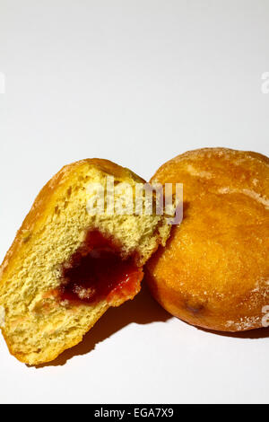 Doughnut sliced in half with jam oozing out Stock Photo - Alamy