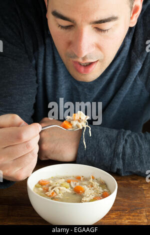 Sick man eating chicken soup at home Stock Photo - Alamy