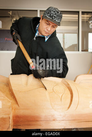 Master carver Chief Ray Natraoro, or Ses Siyam, works on a welcome ...