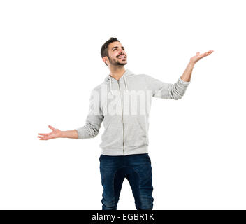 Good looking young man catching something with is hands, with copy ...