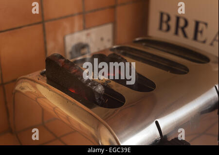 risk of fire smoking burning toast forgotten in the toaster in kitchen ...