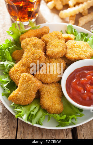 Crispy golden fries, nuggets, onion rings, and dark bread slices served ...