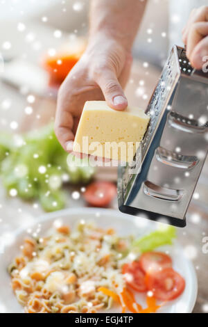 Man cooking pasta, grating cheese Stock Photo - Alamy