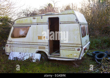 An old, run-down caravan has been parked on a lawn for the rest of its ...