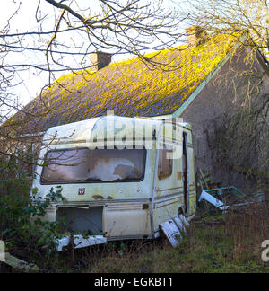 An old, run-down caravan has been parked on a lawn for the rest of its ...