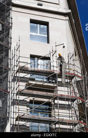 scaffolding scaffolder builder erecting scaffold at height with City ...
