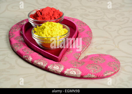Heap of colorful gulaal in the bowls are leading to colorful strip of ...