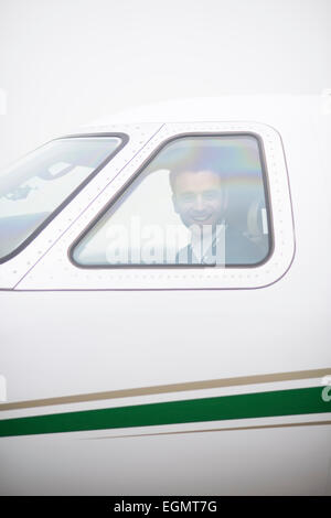 Pilot looking out cockpit window Stock Photo - Alamy