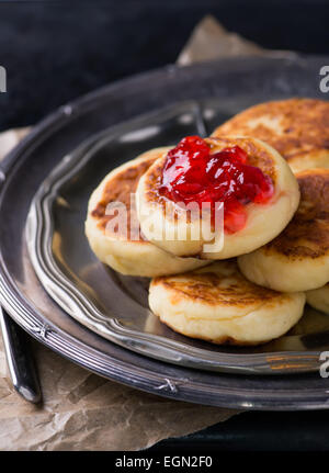 Cottage cheese pancakes, syrniki, on a light background. Copy space ...