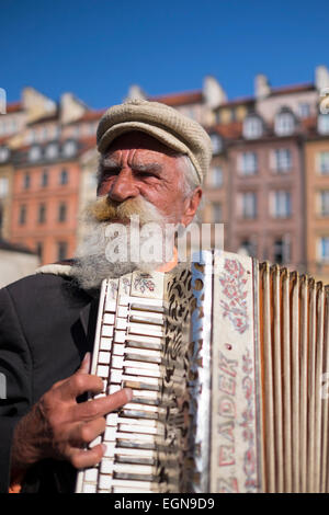 Elderly man busking in Warsaw's Old Town, Poland Stock Photo - Alamy